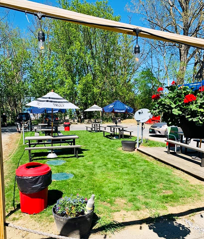 String lights sway above picnic tables in the outdoor seating area &ndash; Vermont's summer perfection captured in one burger-friendly garden.