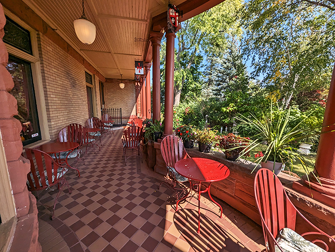 The castle's wraparound porch provides a charming setting for outdoor dining, where Victorian architecture meets modern culinary excellence.