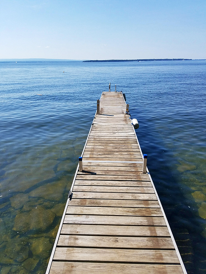 A wooden walkway to nowhere and everywhere &ndash; inviting contemplation, cannonballs, and the occasional fishing line cast with hope.