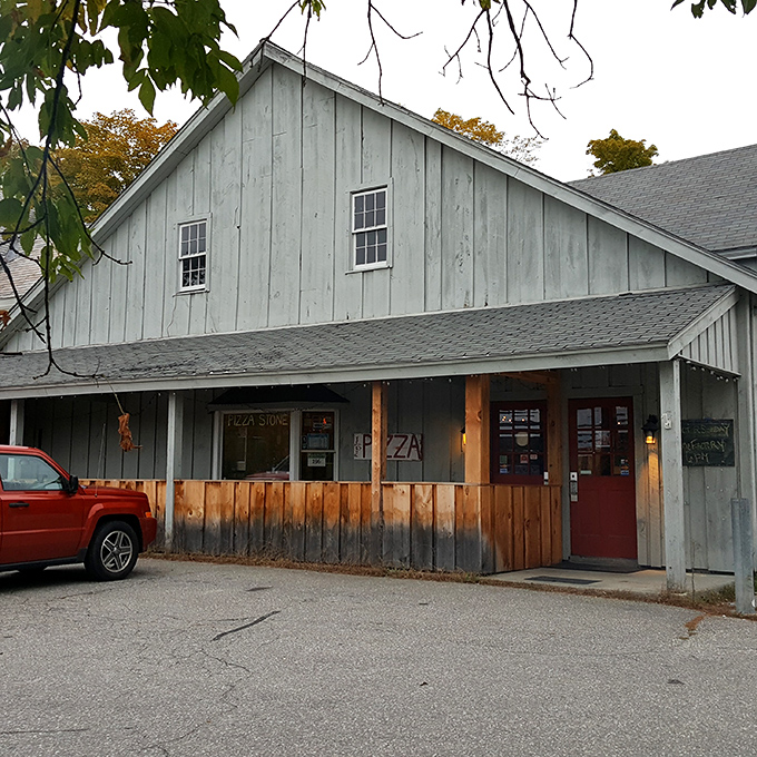 The Pizza Stone's weathered exterior houses wood-fired ovens where pizza magic happens &ndash; proof that rustic buildings often hide culinary treasures.