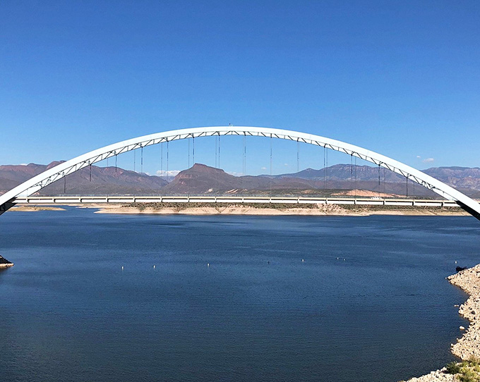 This graceful bridge arches over Roosevelt Lake's blue waters, connecting shorelines while providing Instagram-worthy views in every direction.