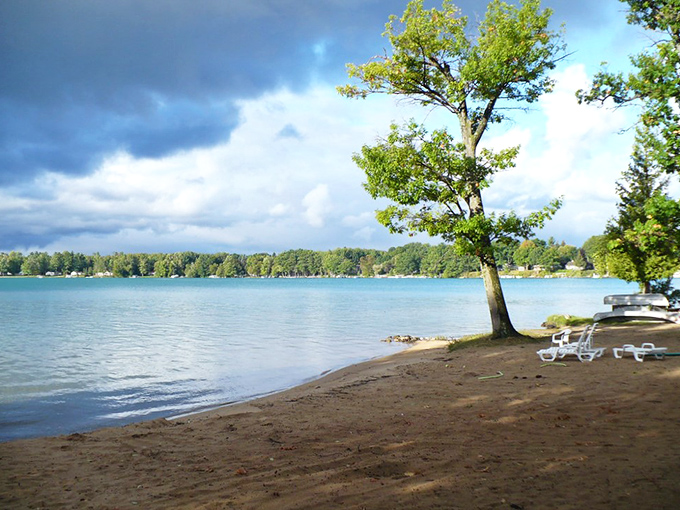 Postcard-perfect panorama: The vibrant turquoise waters of Elk Lake stretch to meet the horizon under Michigan's big sky.