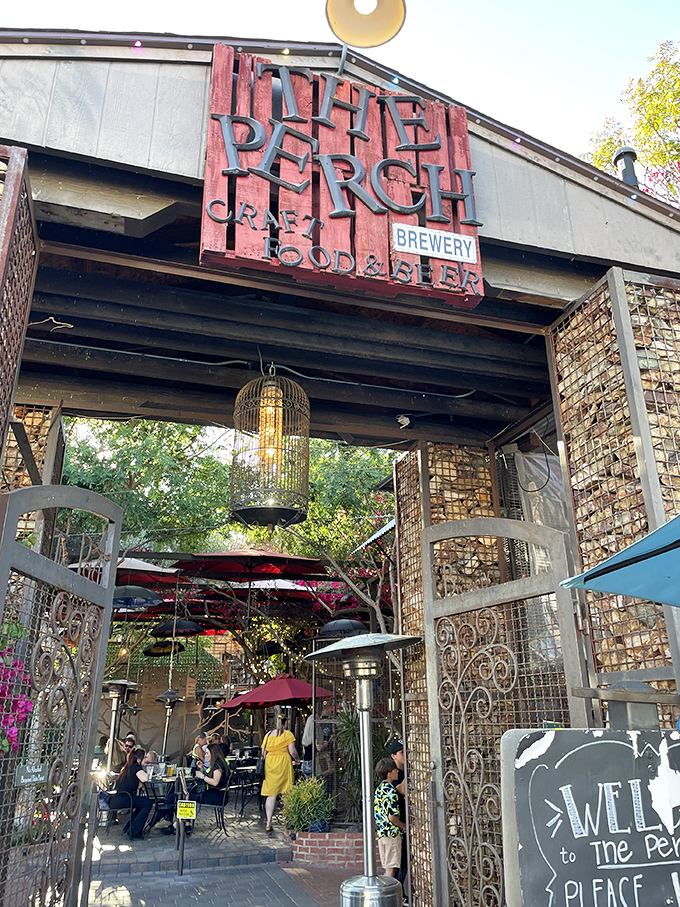 The Perch's weathered wooden sign announces its dual identity &ndash; both brewery and restaurant &ndash; welcoming visitors to this unique establishment.