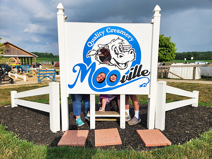 The iconic Moo-Ville sign stands as a beacon for ice cream pilgrims, promising dairy delights and farm fun just beyond its friendly bovine welcome.