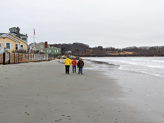 Three beachcombers stroll the shoreline, continuing a tradition as timeless as the tides themselves.