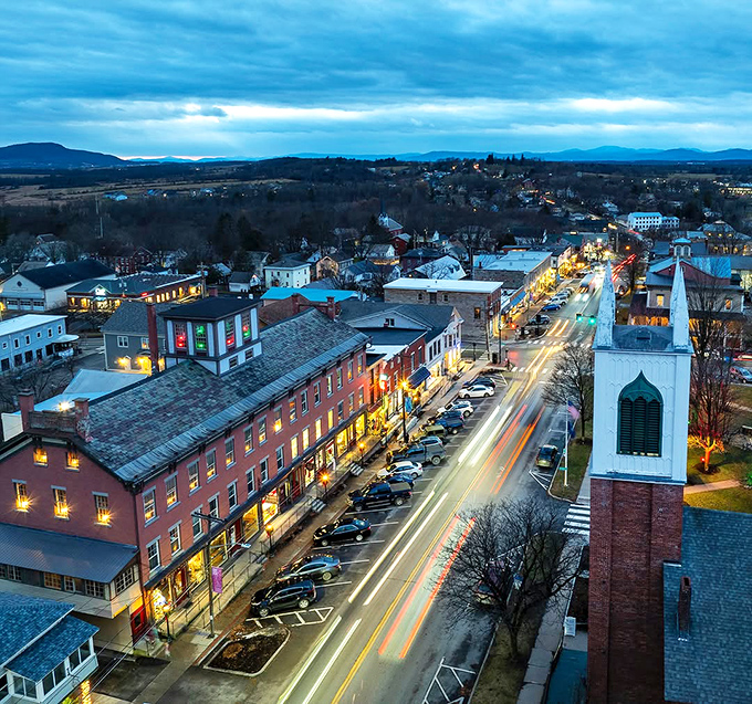 Vergennes transforms into a twinkling wonderland at night, its historic buildings illuminated against the backdrop of Vermont's starry sky.