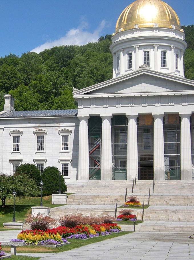 Meticulously maintained gardens frame the Vermont State House, bursting with color and creating a park-like setting for the capital building.