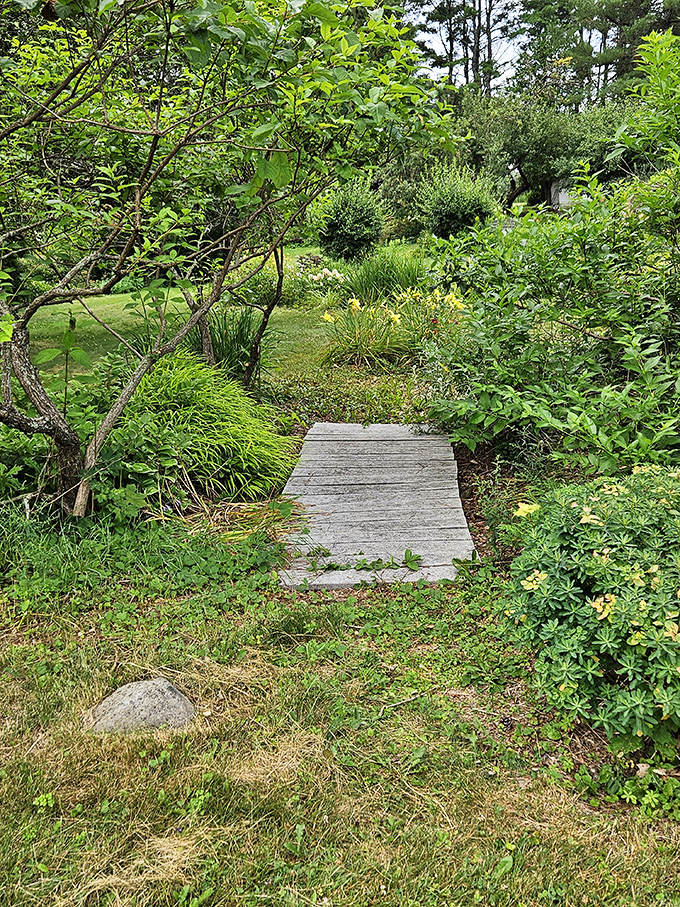 This weathered wooden footbridge invites visitors to cross into another garden room &ndash; the perfect transition between "wow" and "even more wow."
