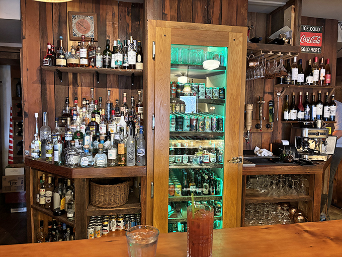 The bar – where local spirits meet mixology expertise in a wood-paneled haven of hospitality.
