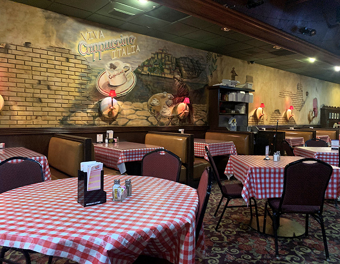 Cozy booths with Italian-inspired murals create intimate dining spaces where countless family celebrations and first dates have unfolded over perfect pizza.