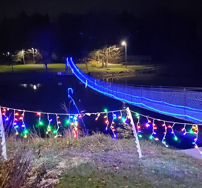 By night, the bridge transforms into a magical light display, its reflection dancing on the water like something from a fairytale.