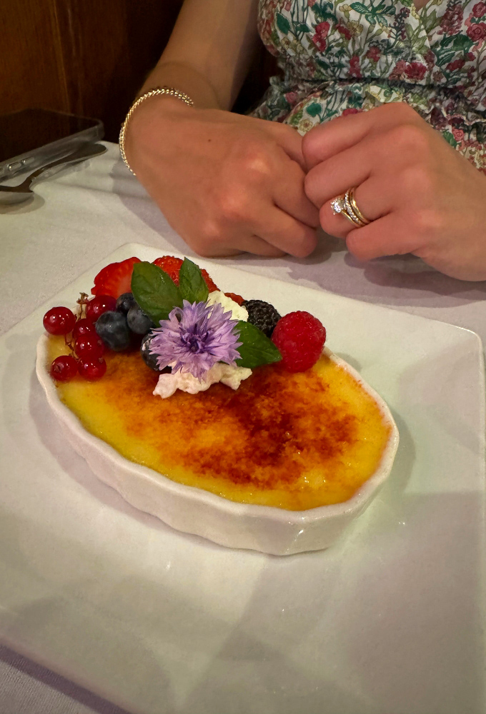 Cr&egrave;me br&ucirc;l&eacute;e with a perfectly caramelized top, adorned with fresh berries &ndash; the sound of cracking that sugar crust is music to a dessert lover's ears.