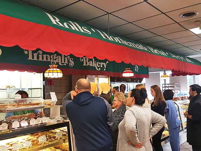 The weekend rush &ndash; a beautiful ballet of pastry selection. Notice how everyone maintains perfect bakery etiquette despite the siren call of cannoli.