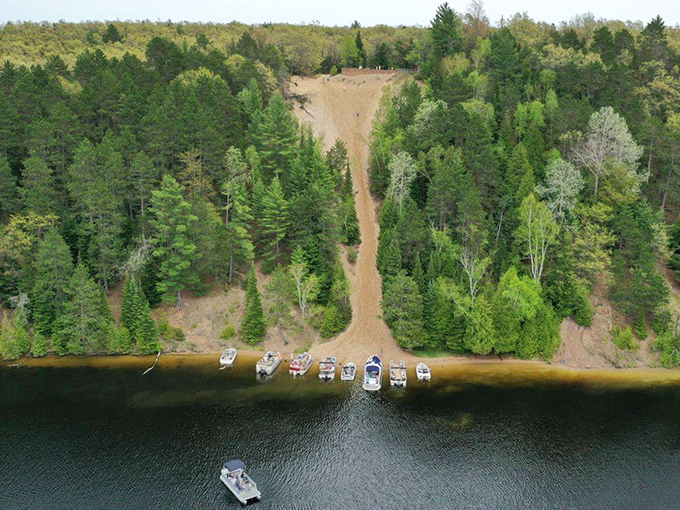 A bird's-eye perspective reveals the pond's perfect contours, carved by ancient glaciers with an artist's attention to detail.