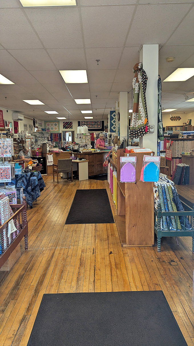 Warm wooden floors have supported countless quilters' journeys through this fabric wonderland, each creak telling stories of creative adventures past.
