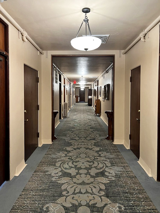This hallway has witnessed nearly a century of footsteps – some belonging to the living, others... well, let's just say the carpet muffles sounds from both worlds.