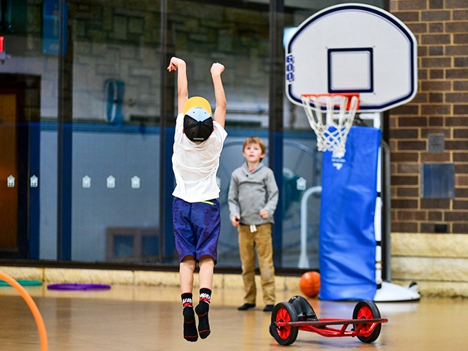 Junior basketball stars practice their jump shots at hoops scaled for humans still mastering the concept of height and gravity.