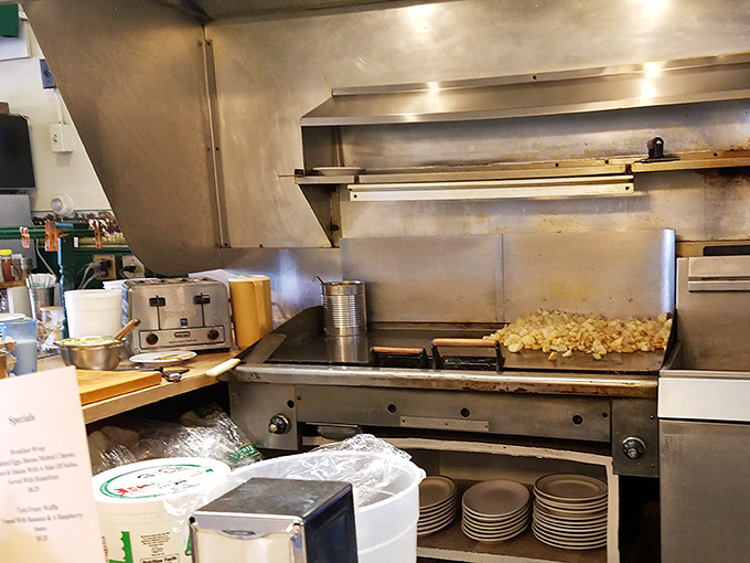The kitchen in action, where short-order skill turns breakfast classics into a delicious morning art form.