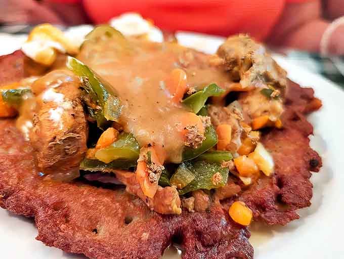 This isn't just a potato pancake &ndash; it's a crispy canvas topped with savory stew that makes ordinary hash browns weep with inadequacy.