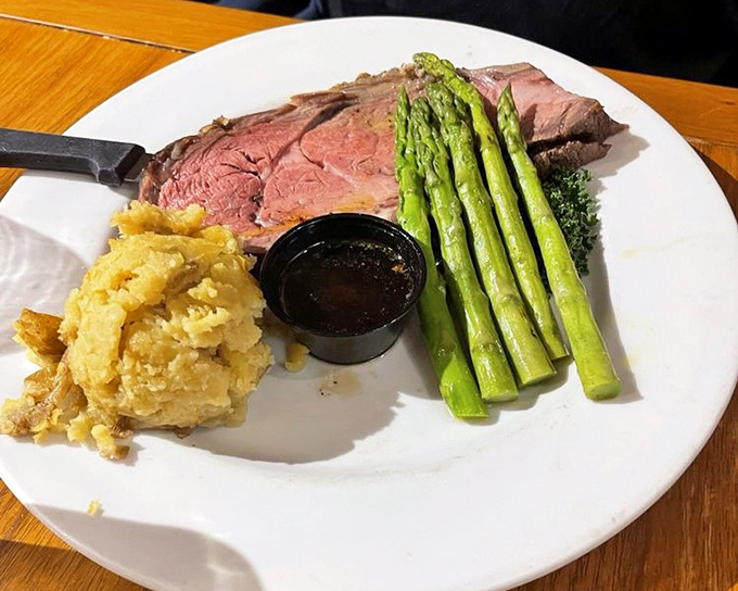 Prime rib so perfectly pink it makes vegetarians question their life choices. Those asparagus spears aren't just sides&mdash;they're supporting actors in a meaty masterpiece.