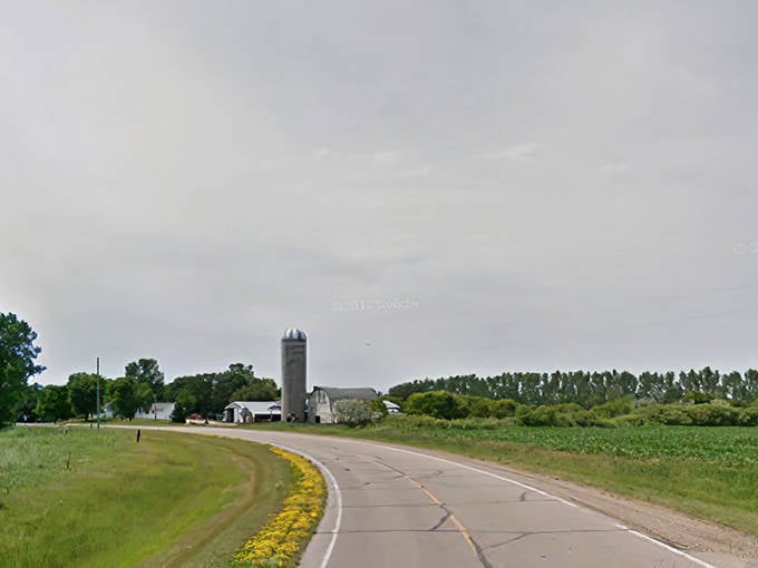 Curved roads lead through Dorothy's quiet landscape, where abandoned structures and maintained homes create a compelling visual dialogue about rural persistence.