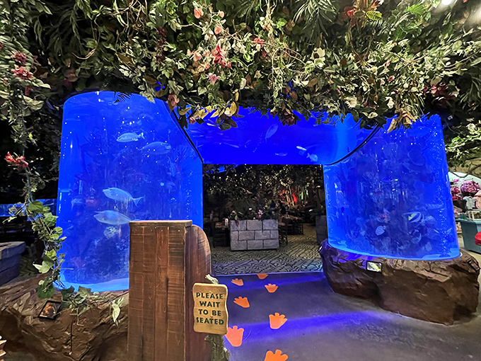 The dramatic blue aquarium entrance sets the tone immediately &ndash; you're not just walking into a restaurant, you're entering another world entirely.