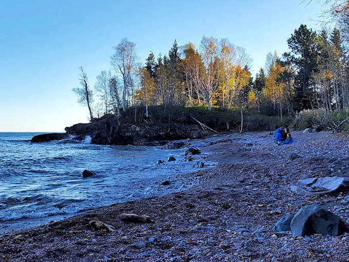 The rugged shoreline beyond the singing beach reveals Superior's raw power, where waves have sculpted rock into natural art installations.