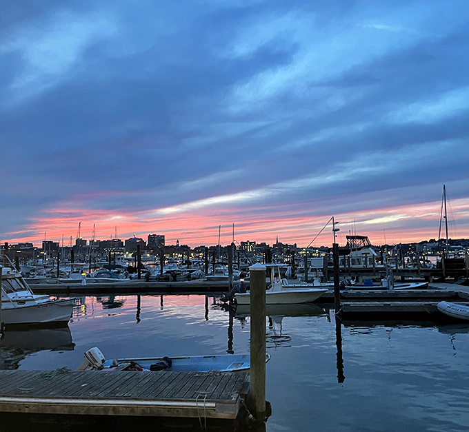 Twilight paints the sky in watercolor hues that no filter could improve. The boats rest after a day's work, just like you will after dinner.