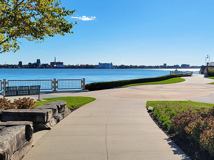 The pathway curves gently along the shoreline, leading visitors on a journey through Detroit's relationship with its most important natural resource.