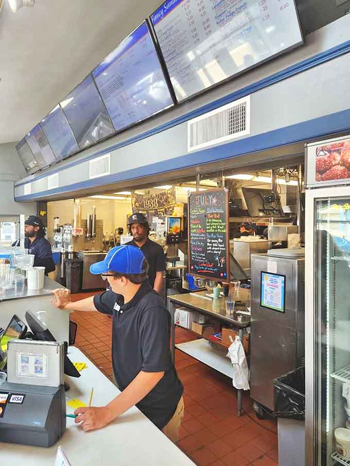 Behind the scenes at Gilles, dedicated staff work their magic, assembling burgers and scooping custard with practiced precision and care.
