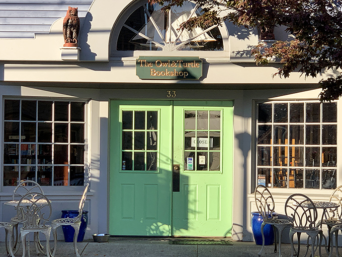 Morning light bathes the storefront in golden possibility, the mint doors standing ready to welcome literary pilgrims.