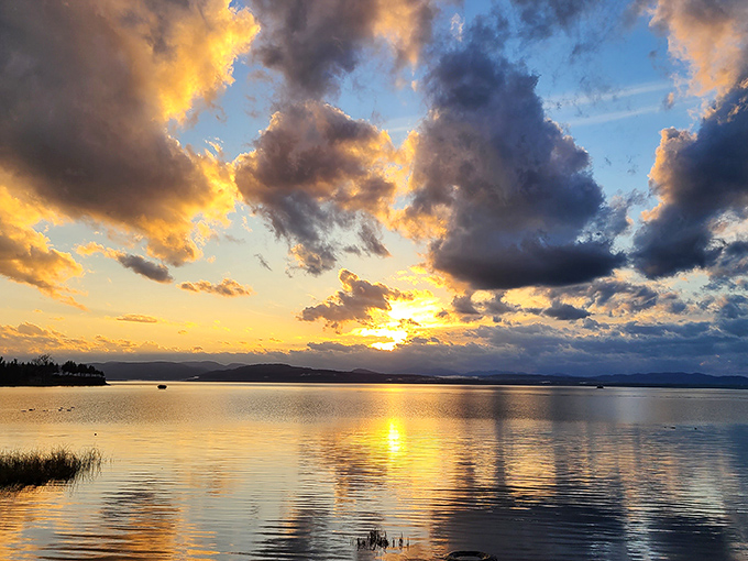 Sunset paints the water with impossible colors, turning an ordinary evening into a masterpiece of light and reflection.