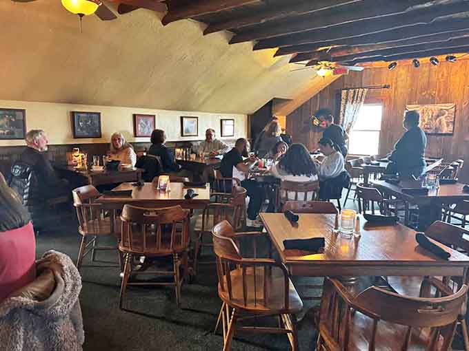 Upstairs seating offers a more intimate dining experience, where sloped ceilings and warm wood create a cocoon of culinary comfort.