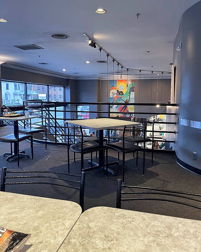 The second-floor sanctuary offers respite from the bustle below, perfect for people-watching or contemplating a second slice.