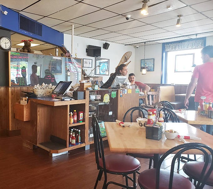 The staff moves with practiced efficiency behind the counter, part of the authentic community experience that defines Blue Water Cafe.