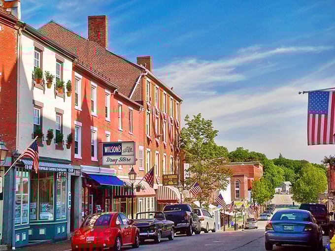 Bath's main street features classic New England architecture with red brick buildings and American flags fluttering in the breeze.