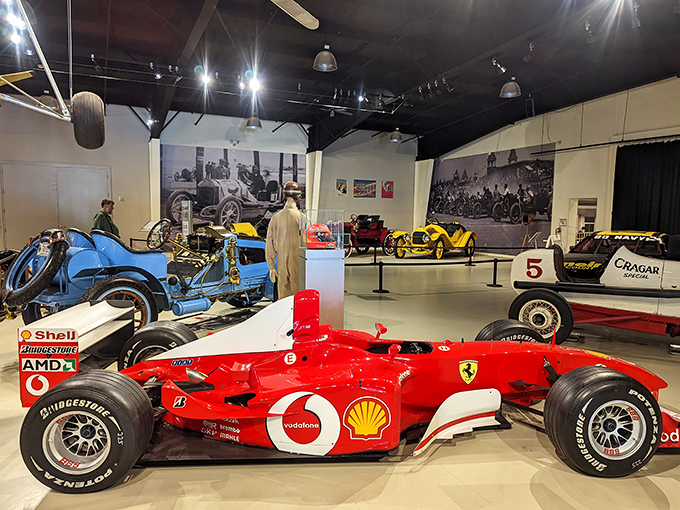 Vintage race cars gleam under museum lights at Owls Head, where transportation history comes alive through meticulously preserved vehicles.