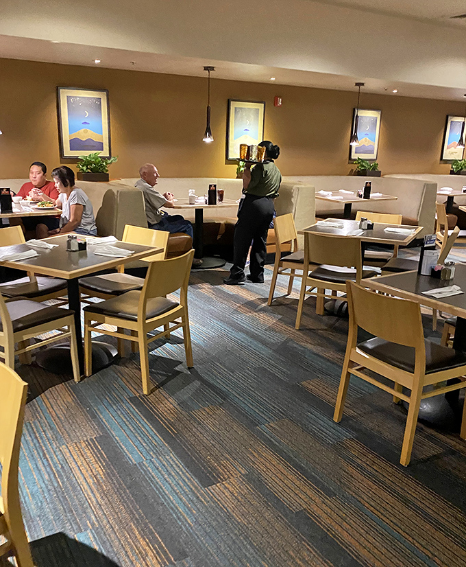 Natural light filters through the dining area, highlighting comfortable seating arrangements perfect for family gatherings or casual meals with friends.