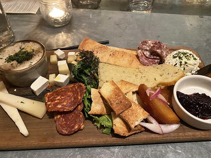 A charcuterie board that's basically a work of art, featuring cured meats, cheeses, and accompaniments arranged with obvious care and attention.