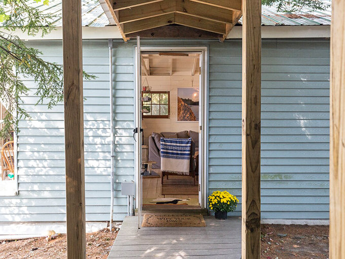 A humble blue doorway that separates ordinary life from your temporary reign as monarch of this woodland domain.