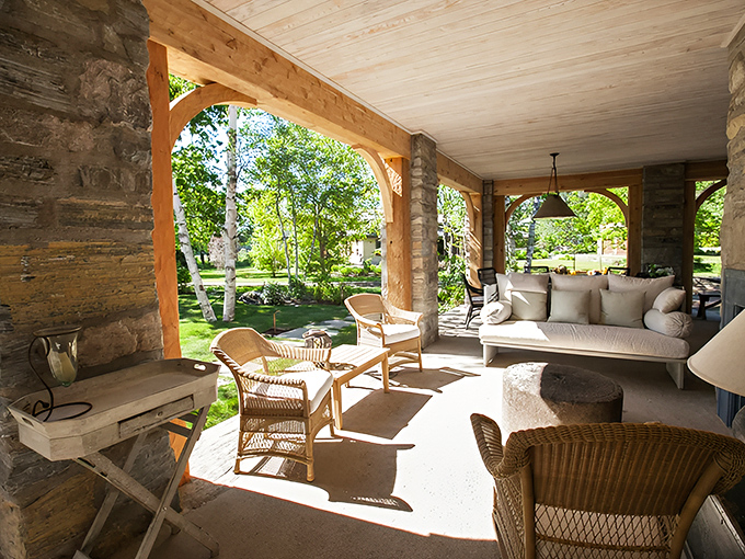 The covered porch creates an outdoor living room where Maine's natural beauty becomes part of the daily experience.