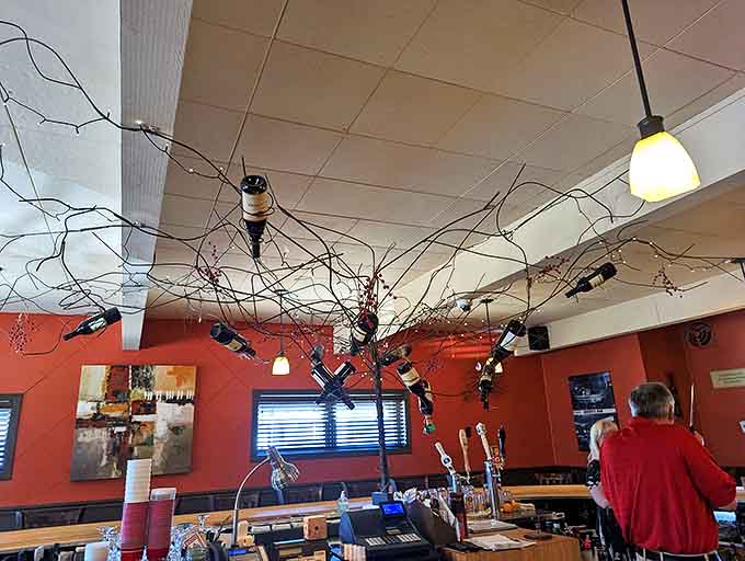 Ceiling decor that proves imagination trumps budget &ndash; twisted branches and twinkling lights creating woodland magic above cocktail conversations.