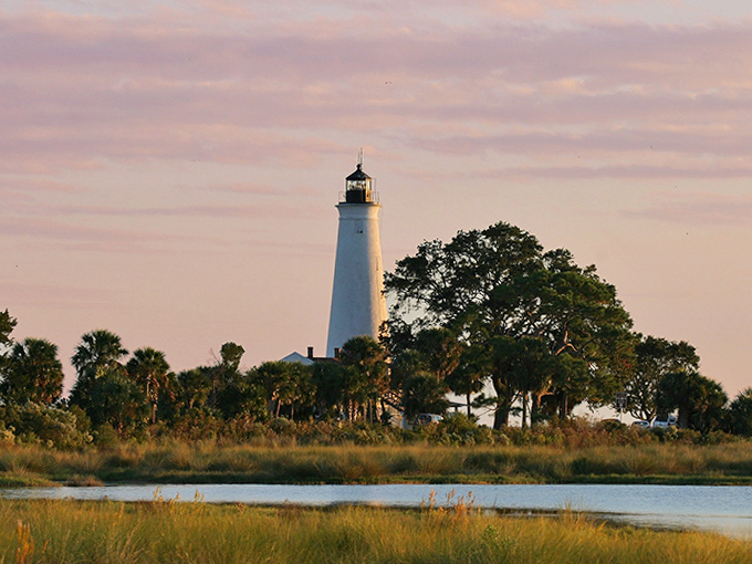 Twilight bathes the lighthouse in gentle hues, creating the kind of moment that makes amateur photographers look professional.
