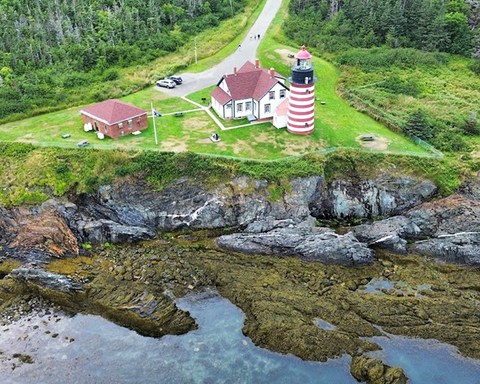 Where land meets legend: The lighthouse stands sentinel on its rocky promontory, a perfect harmony of human ingenuity and natural grandeur.
