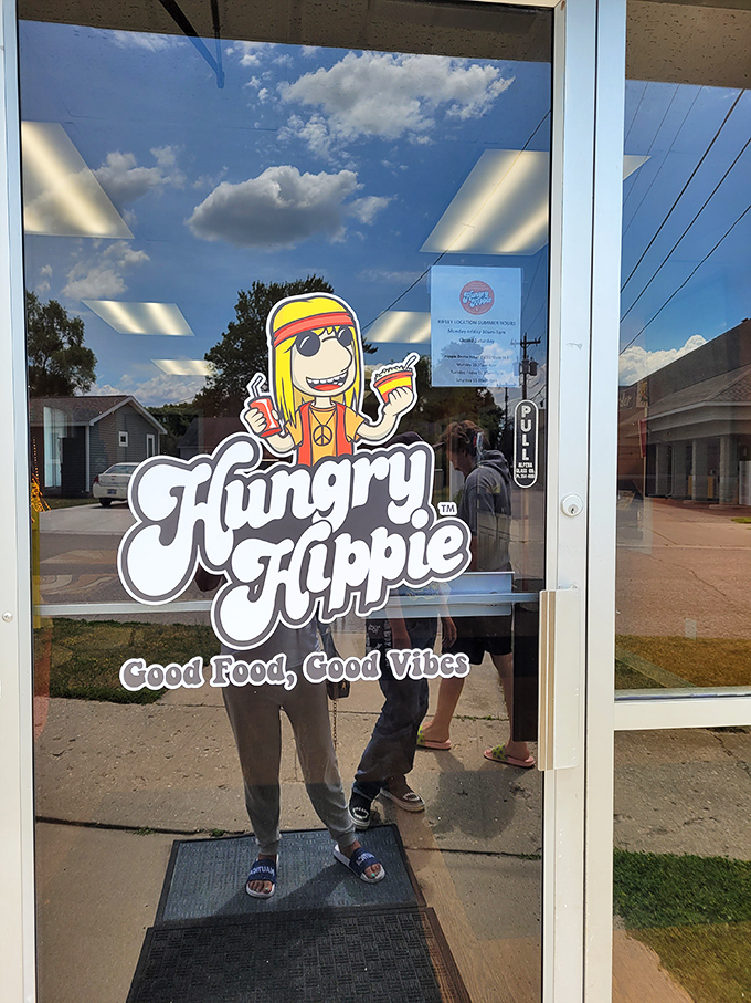 The entrance welcomes diners with the Hungry Hippie mascot and the promise of "Good Food, Good Vibes," a promise the restaurant consistently delivers on.
