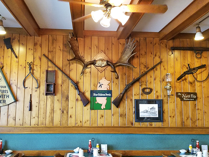 Antlers, rifles, and wooden paneling create an authentic northwoods atmosphere that whispers, "Yes, we know our way around breakfast."