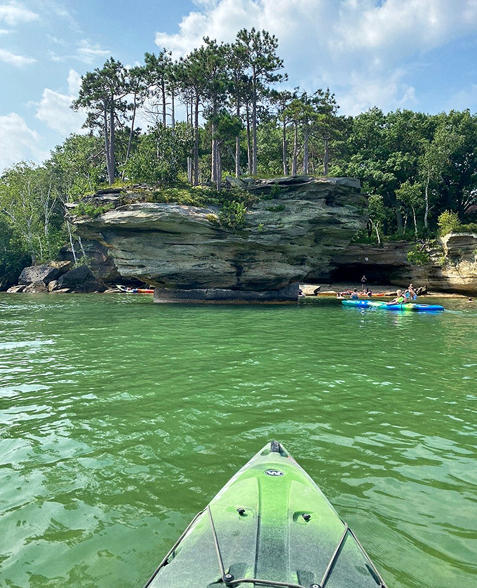 From a kayak's-eye view, Turnip Rock looms larger than expected, its presence commanding attention against the vast blue horizon of Lake Huron.