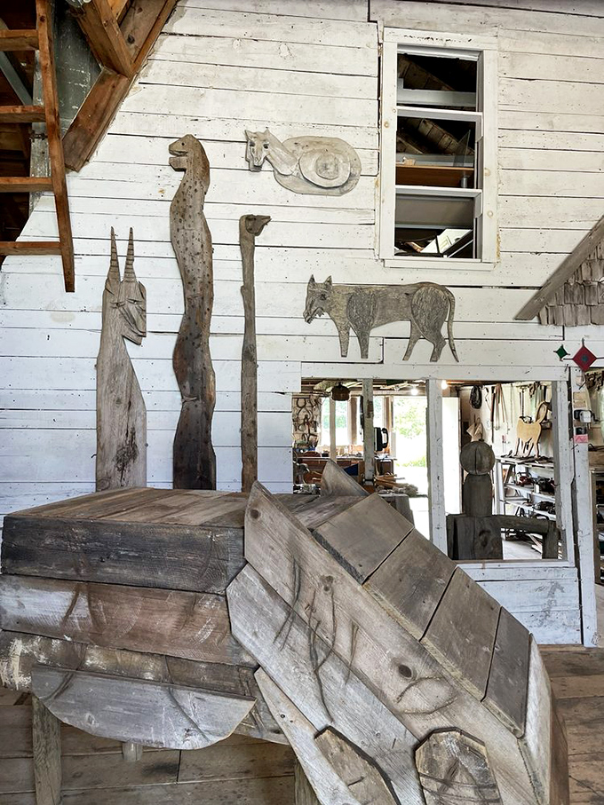 Inside one of the preserve's buildings, wooden creatures climb walls and perch on beams, transforming the space into a fantastical menagerie.