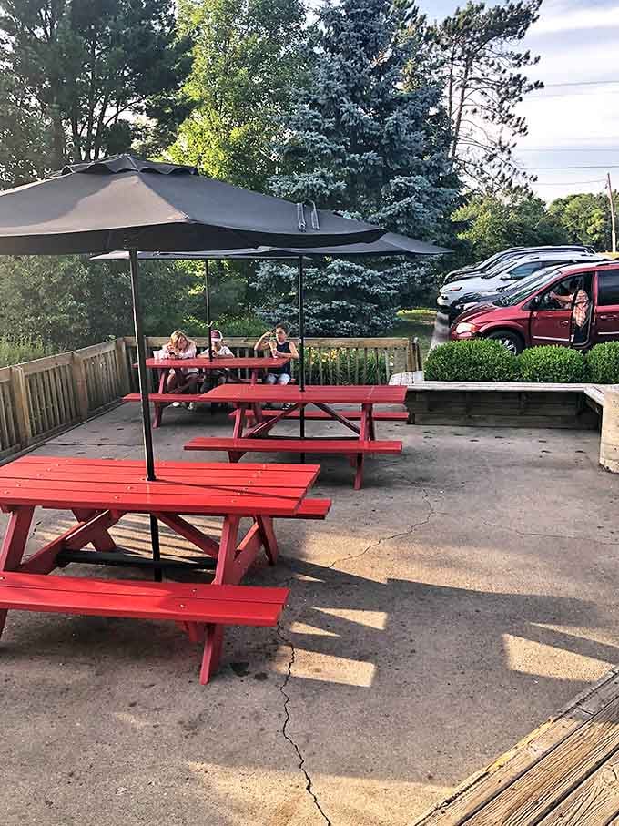 Red picnic tables offer front-row seats to farm views, because ice cream tastes better when cows are part of the scenery.