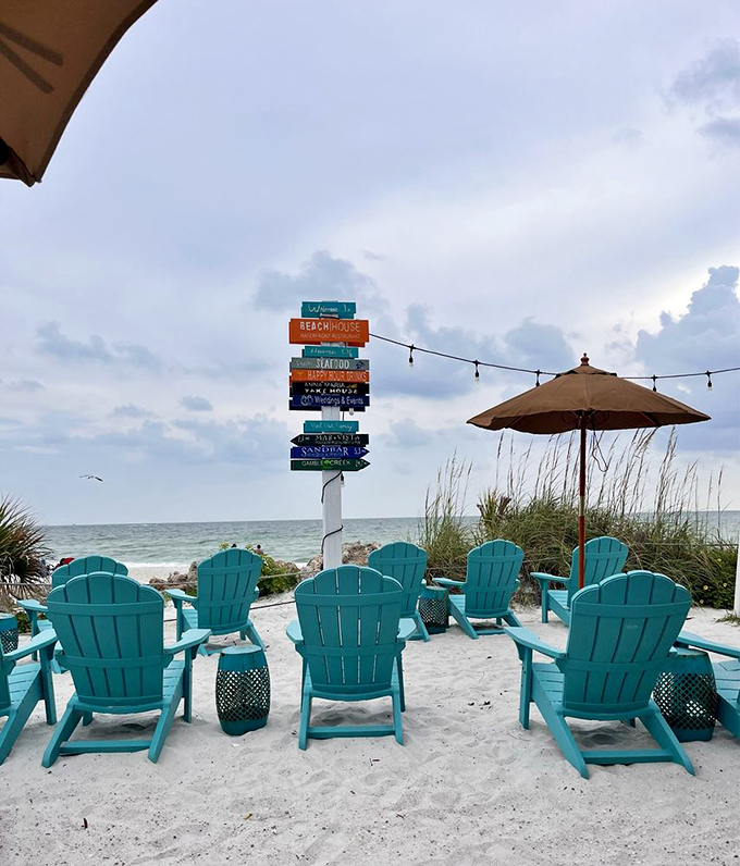 Outside patio: Turquoise Adirondack chairs invite you to sink in and watch the waves, possibly with a cocktail in hand.